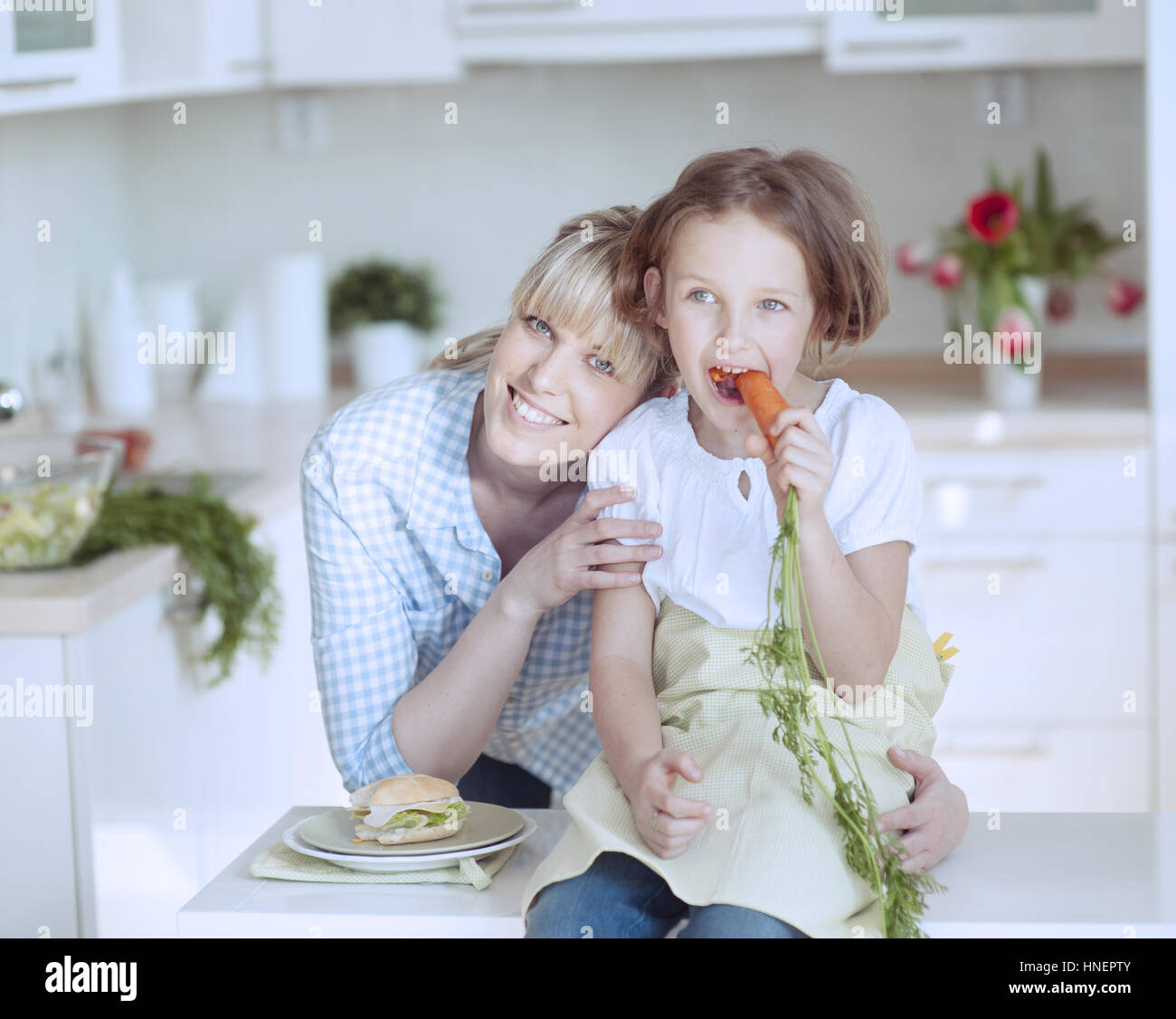 Young girl eating carrot Stock Photo - Alamy