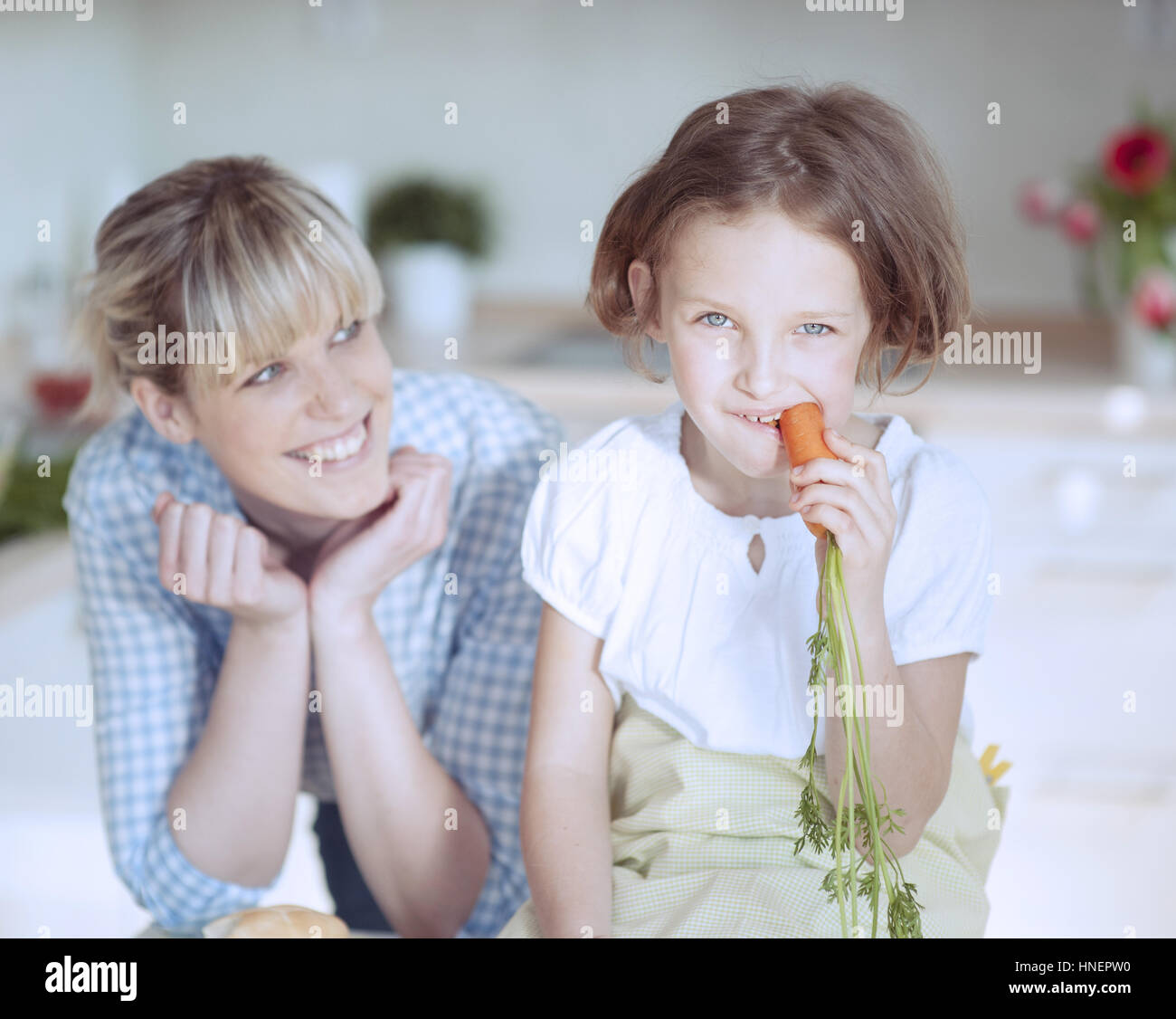 Young girl eating carrot Stock Photo - Alamy