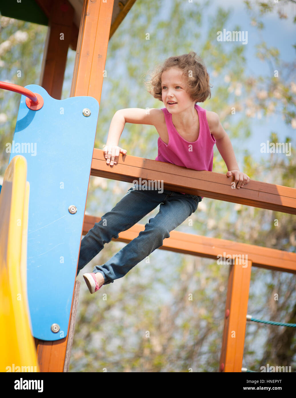 Young girl climbing on childrens playground Stock Photo - Alamy