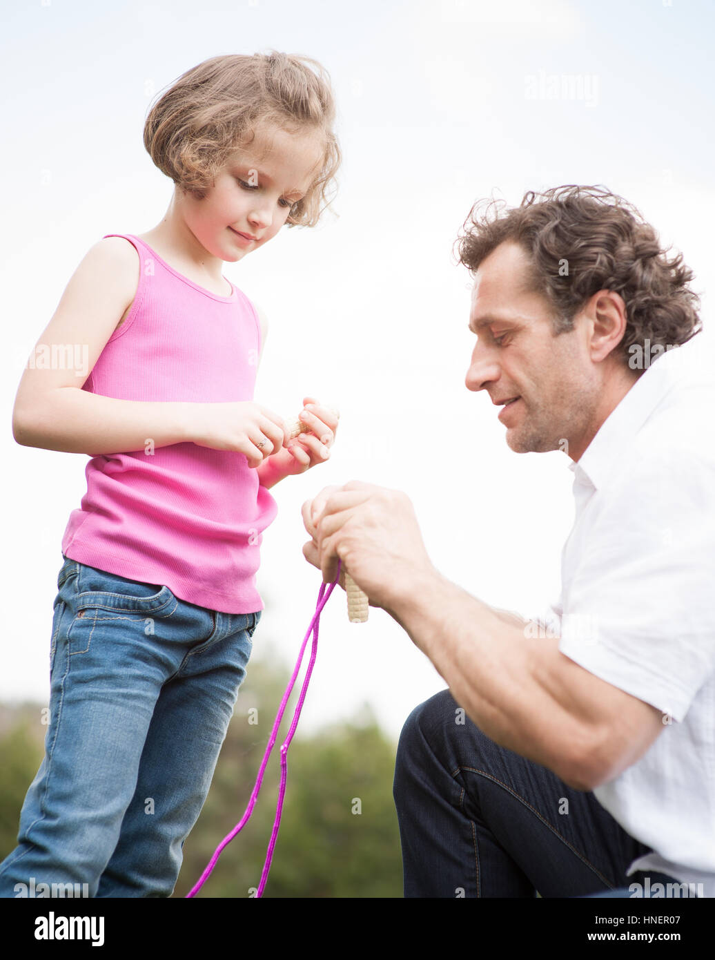 Father and daughter together with skipping rope Stock Photo - Alamy