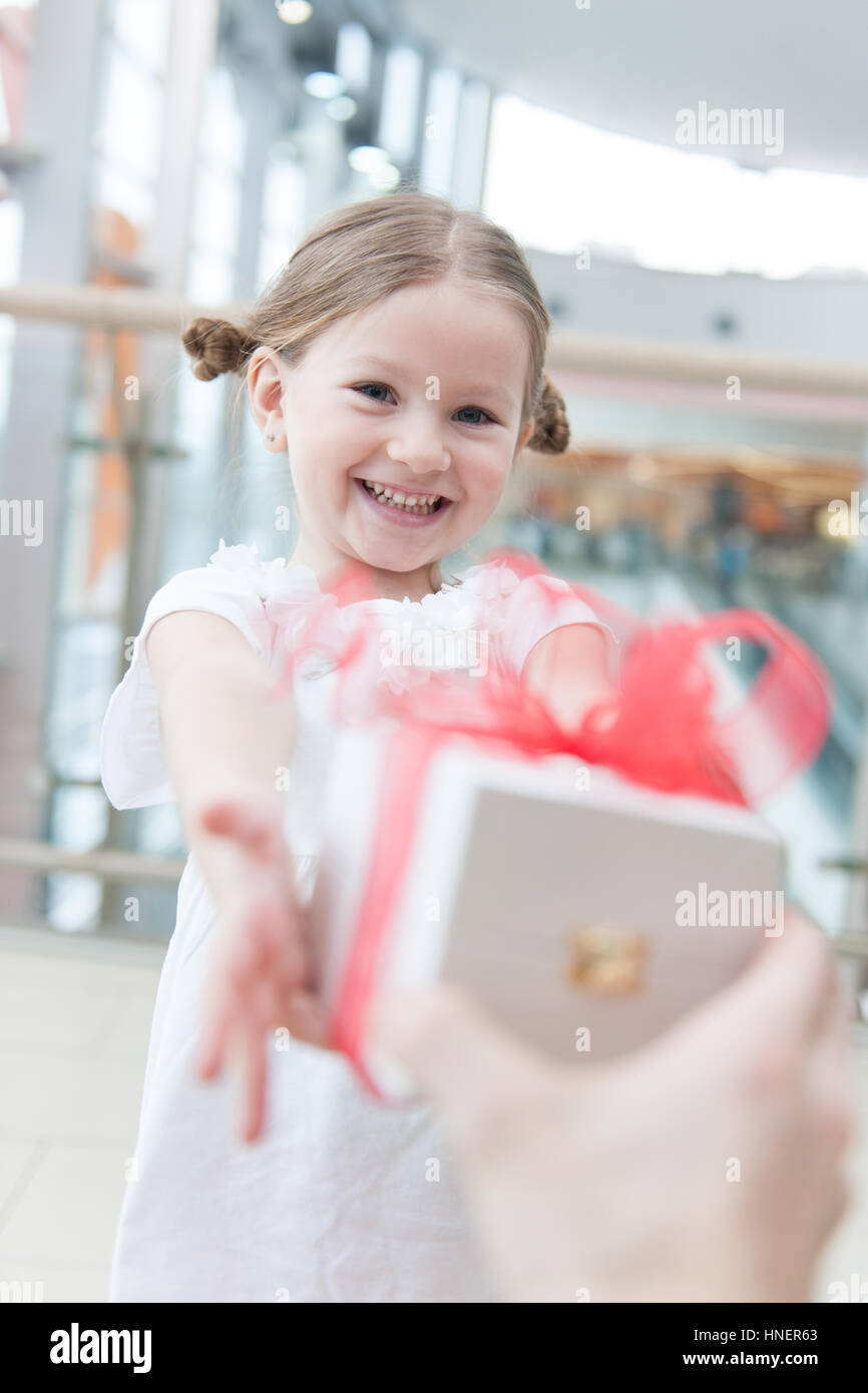Young girl being giving a present Stock Photo - Alamy