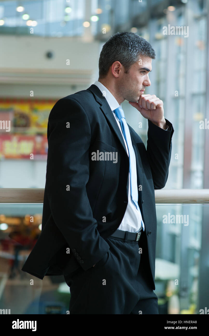Businessman with serious expression looking off camera Stock Photo - Alamy