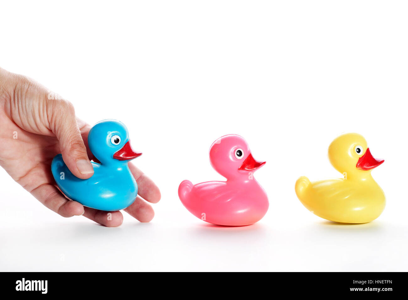three plastic ducks in different colors Stock Photo - Alamy