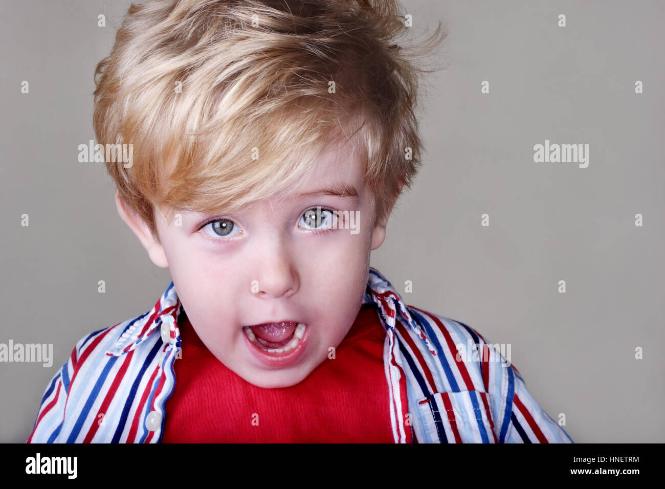 A young boy with surprised expression Stock Photo - Alamy