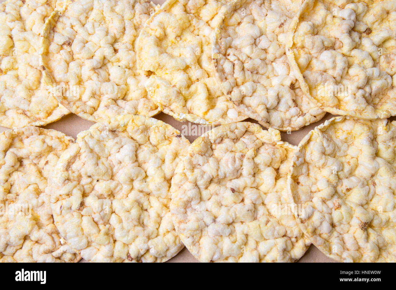Circle shaped salty corn snacks making background Stock Photo - Alamy