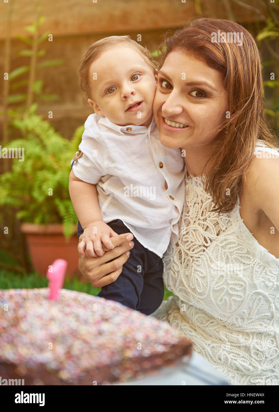 Mom with small kid hugging infront of birthday cake Stock Photo - Alamy