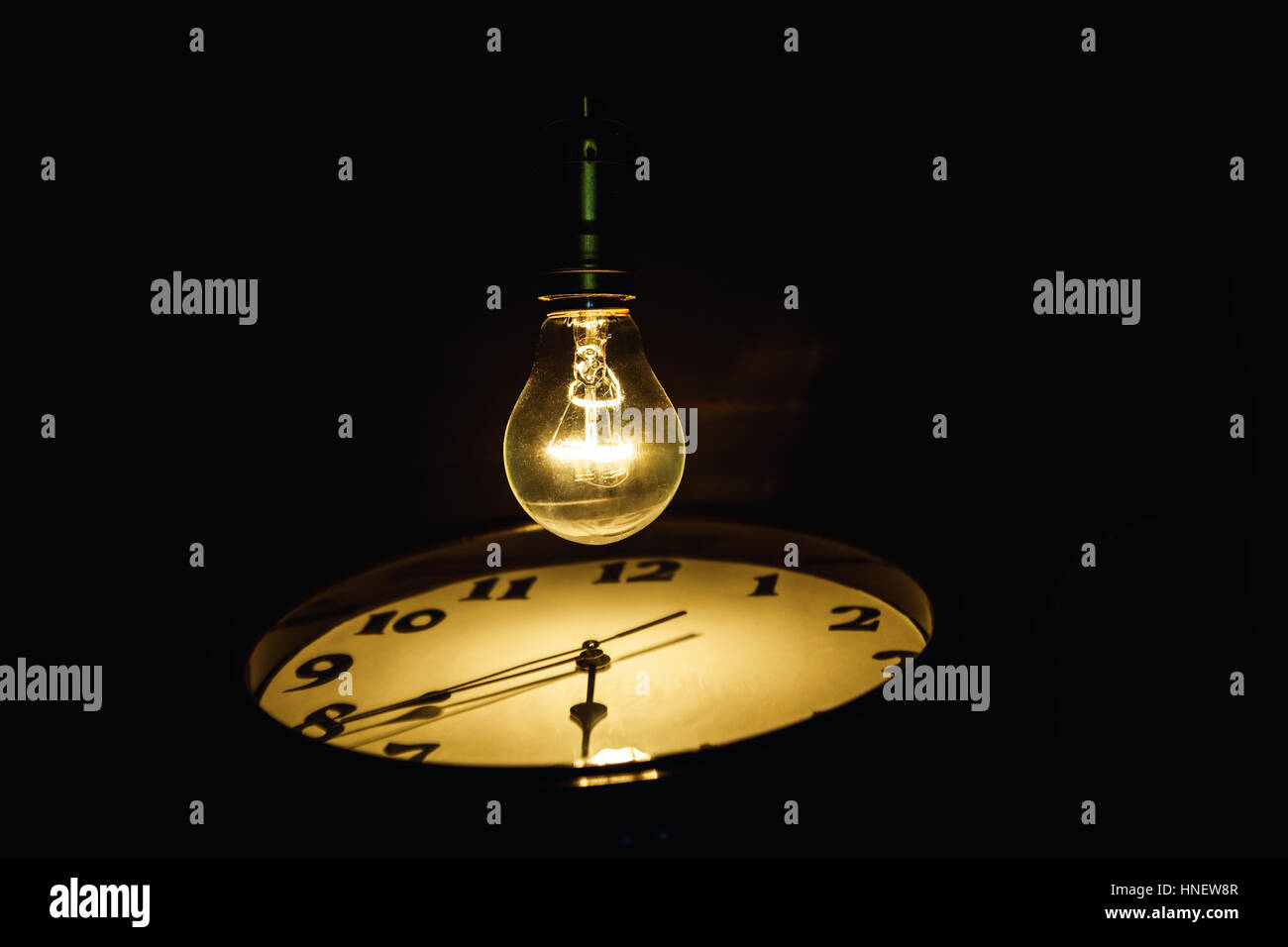 Light bulb and clock, concept of idea Stock Photo - Alamy