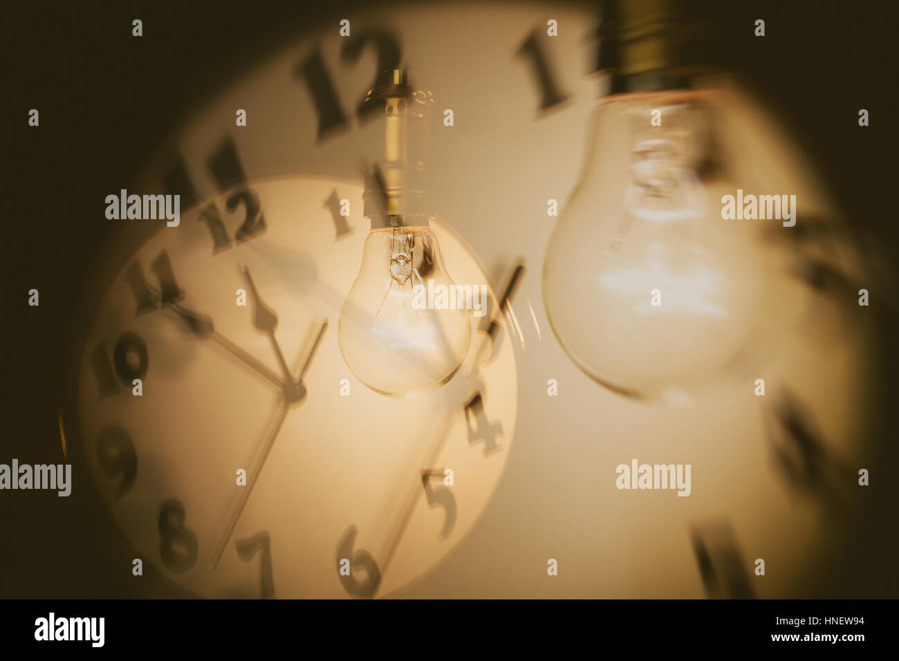 Light bulb and clock, concept of idea Stock Photo - Alamy