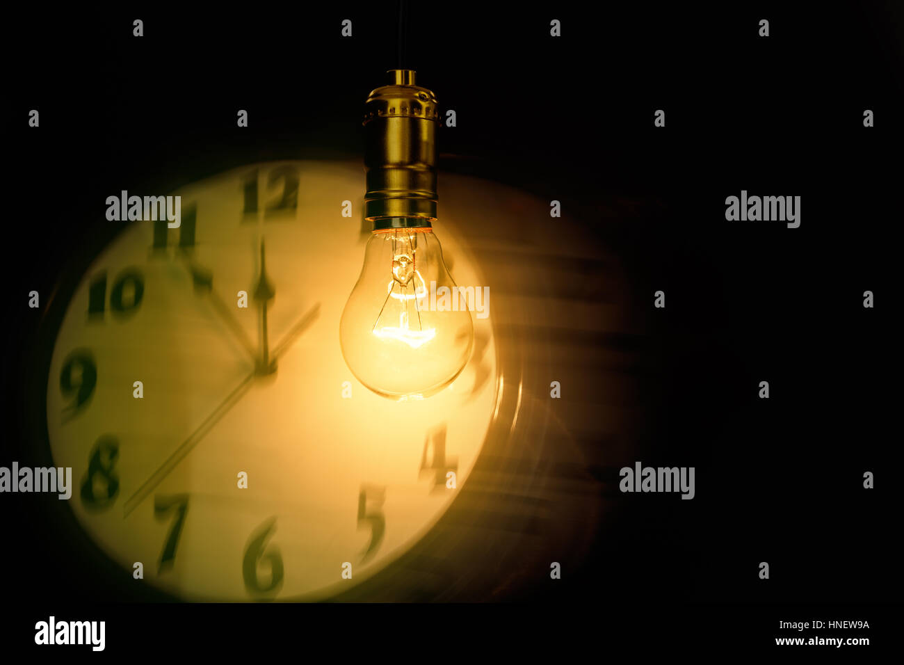 Light bulb and clock, concept of idea Stock Photo - Alamy