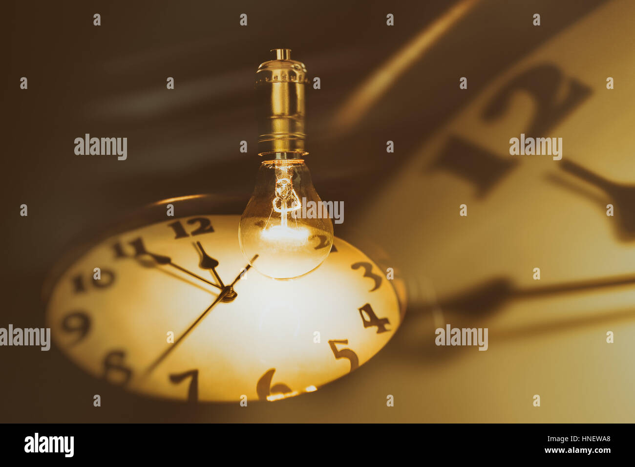 Light bulb and clock, concept of idea Stock Photo - Alamy