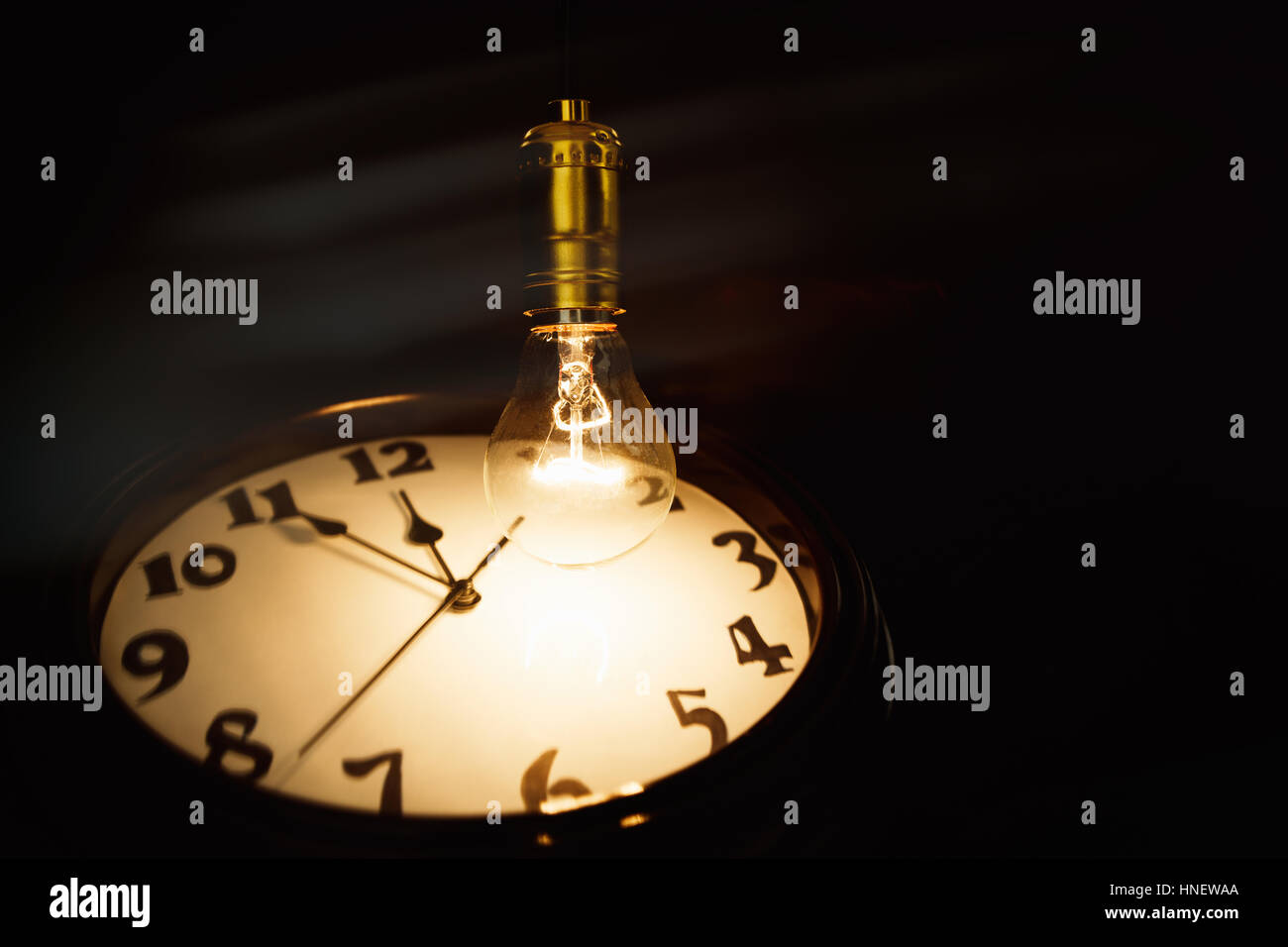 Light bulb and clock, concept of idea Stock Photo - Alamy