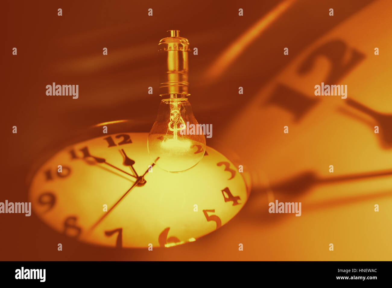 Light bulb and clock, concept of idea Stock Photo - Alamy