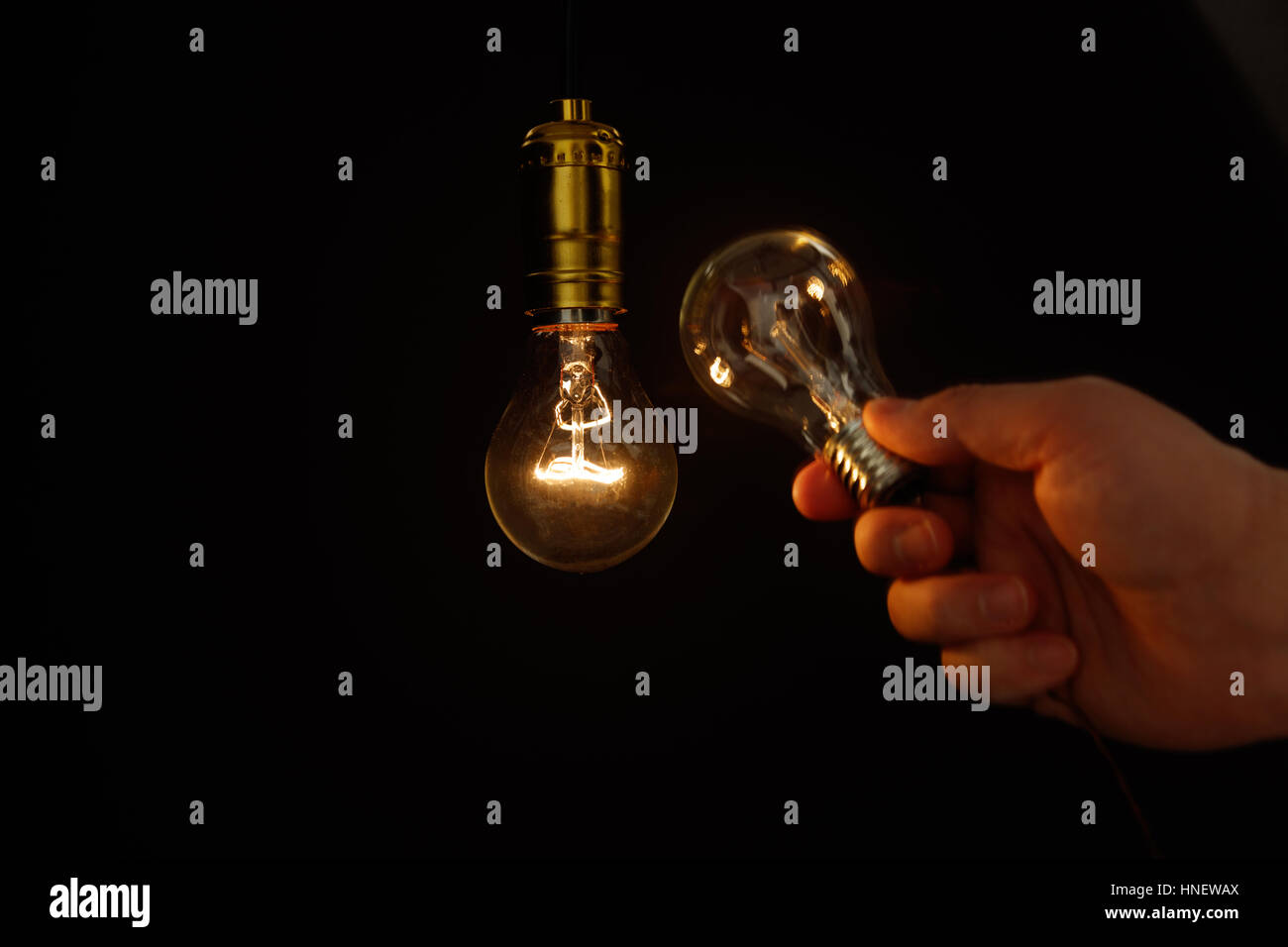 Light bulb and hand, concept of wisdom Stock Photo - Alamy