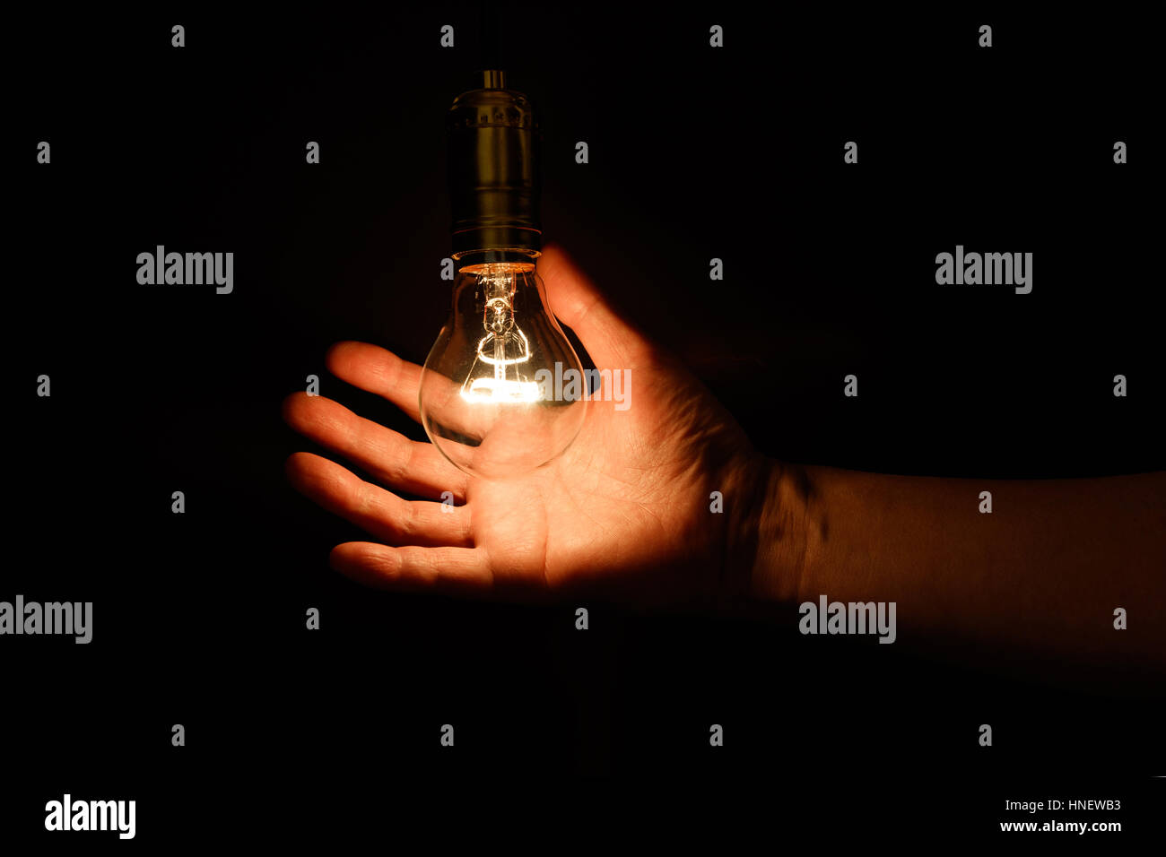 Light bulb and hand, concept of wisdom Stock Photo - Alamy