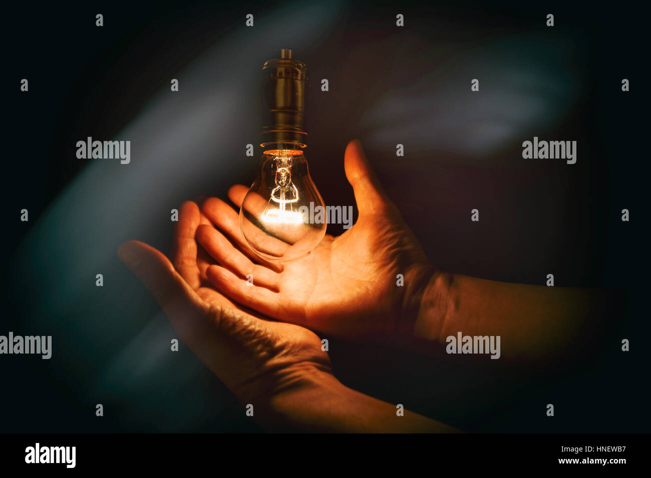 Light bulb and hand, concept of wisdom Stock Photo - Alamy