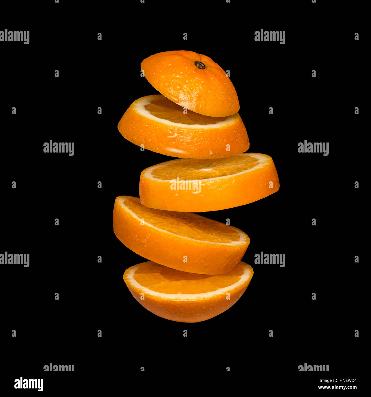 Flying orange. Sliced orange isolated on black background. Levity fruit ...