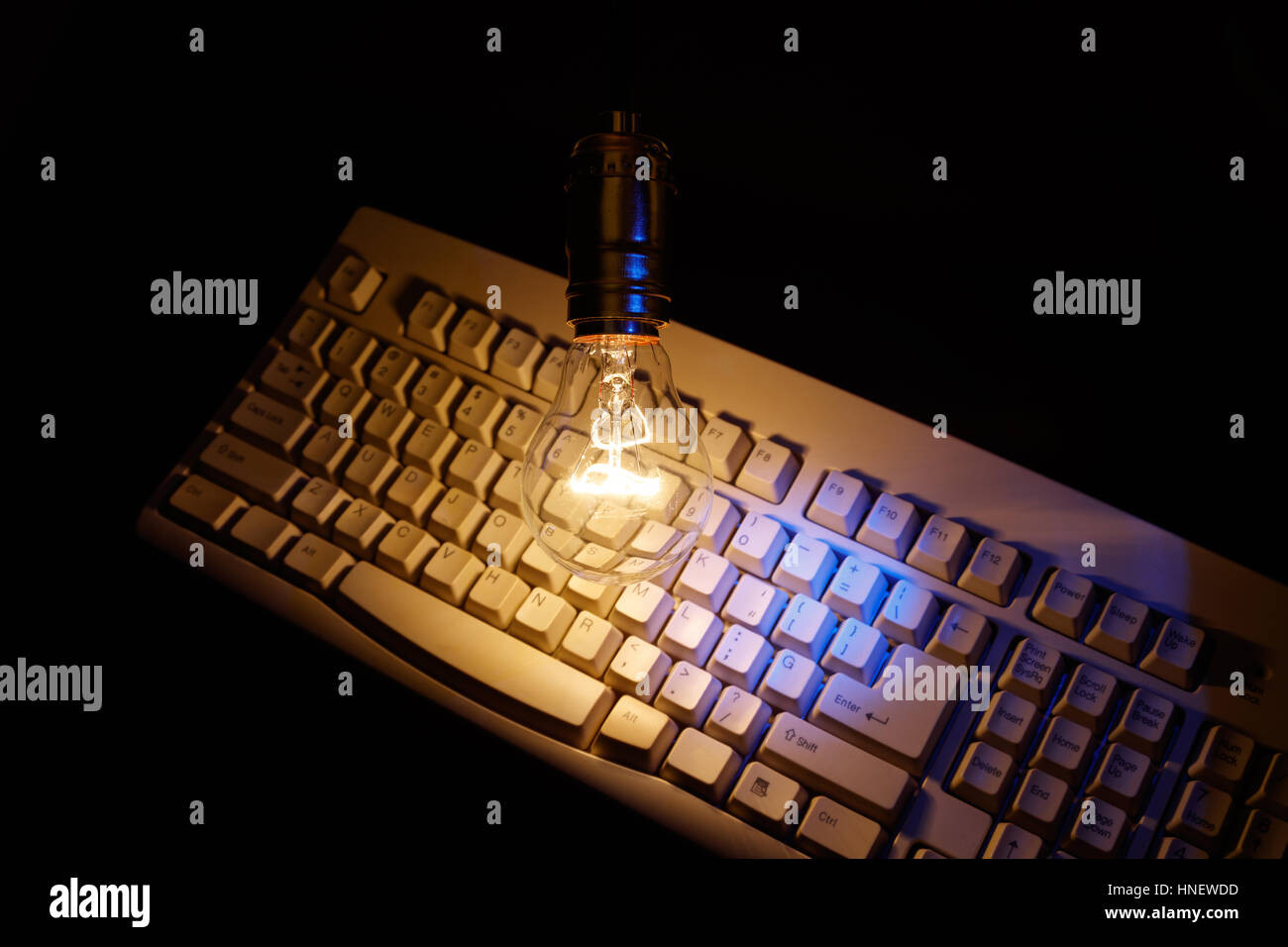 Light bulb and computer keyboard, concept of wisdom Stock Photo - Alamy