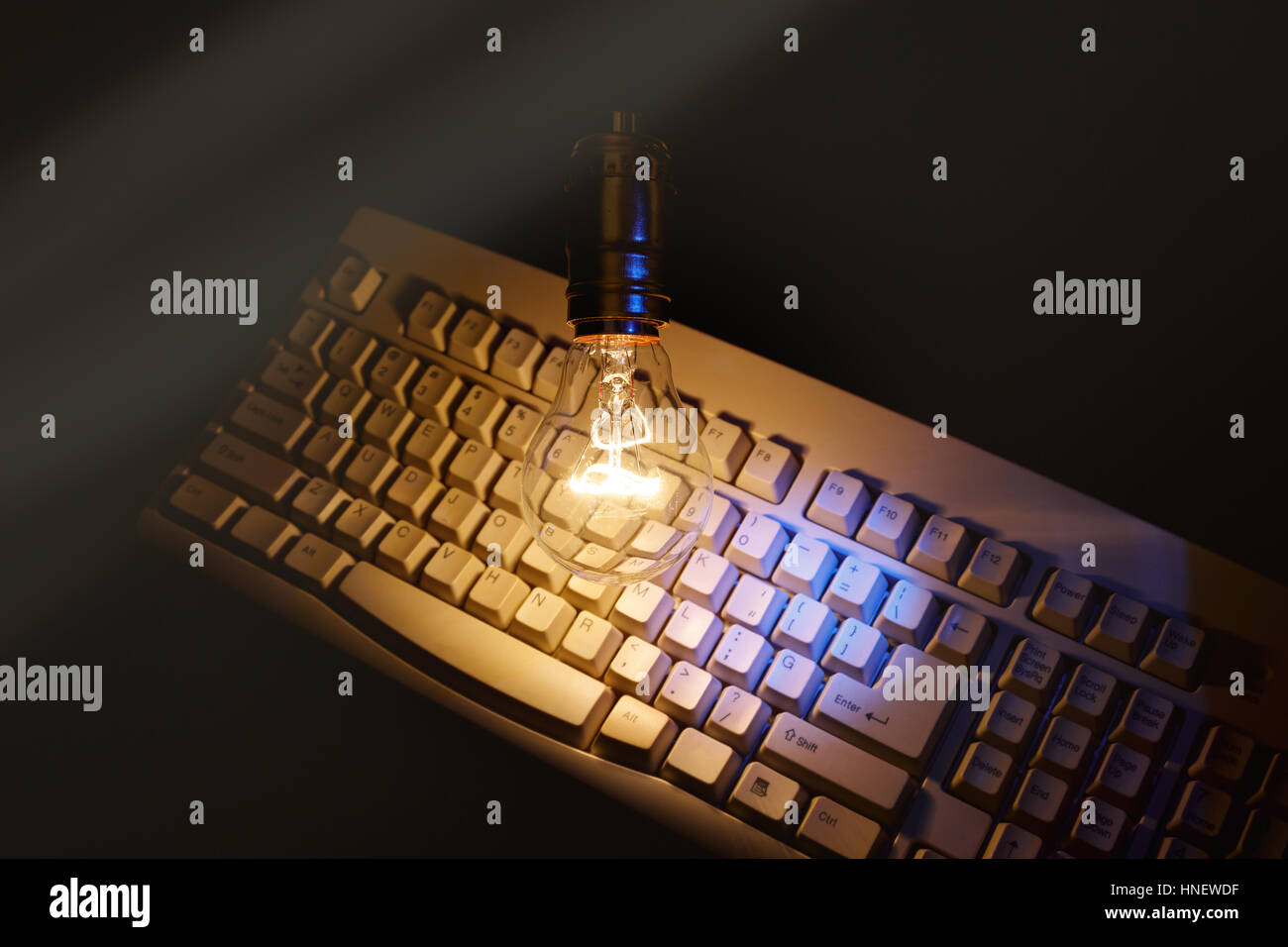 Light bulb and computer keyboard, concept of wisdom Stock Photo - Alamy