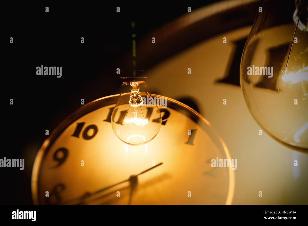 Light bulb and clock, concept of idea Stock Photo - Alamy