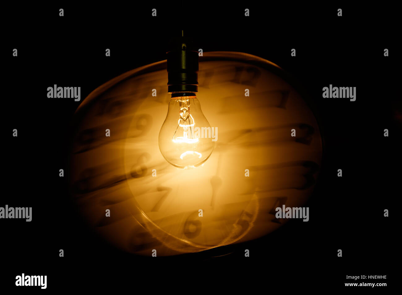 Light bulb and clock, concept of idea Stock Photo - Alamy