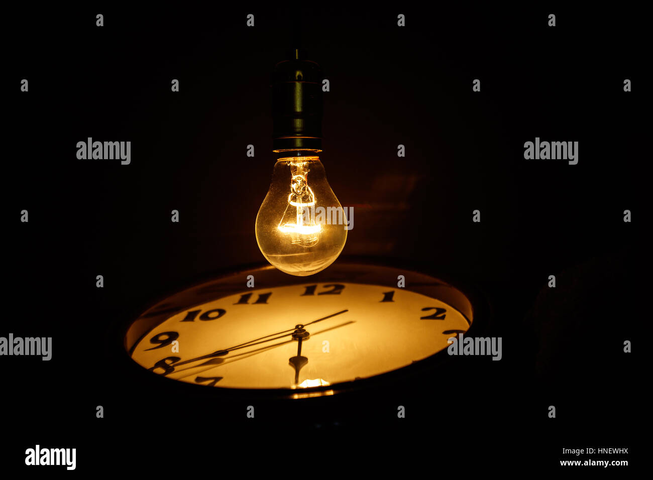 Light bulb and clock, concept of idea Stock Photo - Alamy