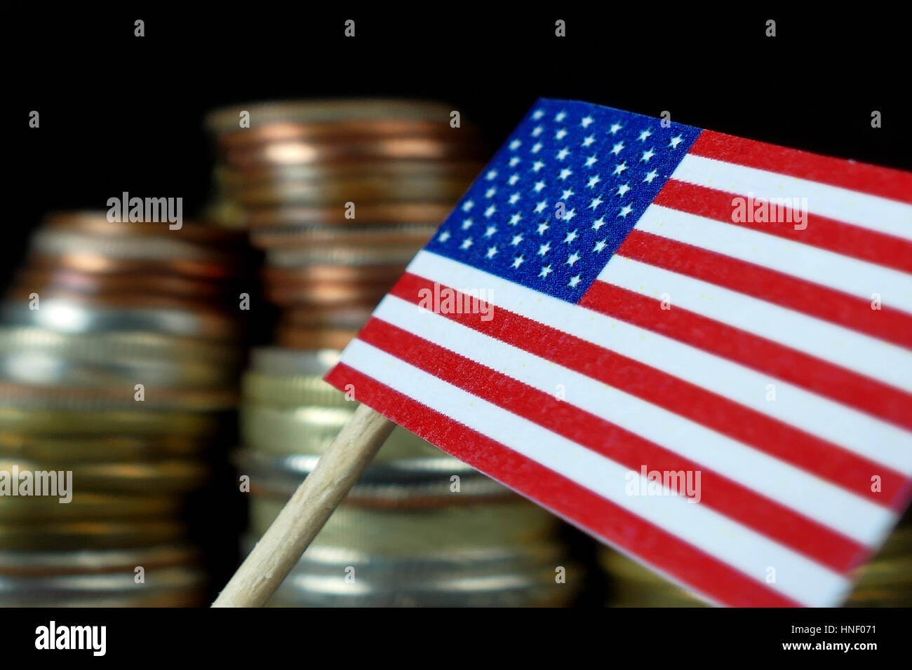 Us american flag waving with stack of money coins aid hi-res stock ...