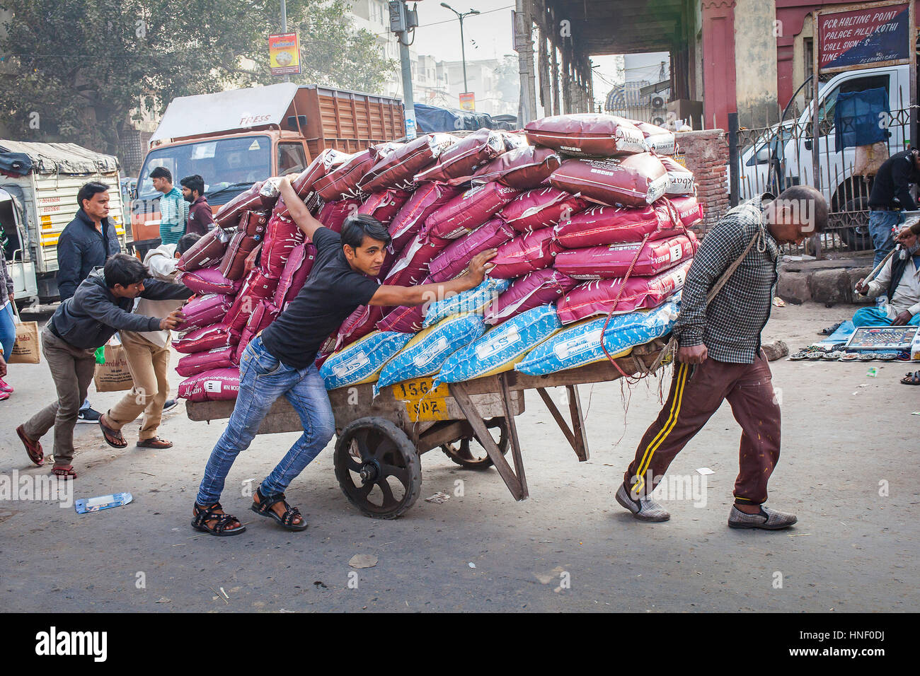 Indian porter man carrying heavy bags hi-res stock photography and ...