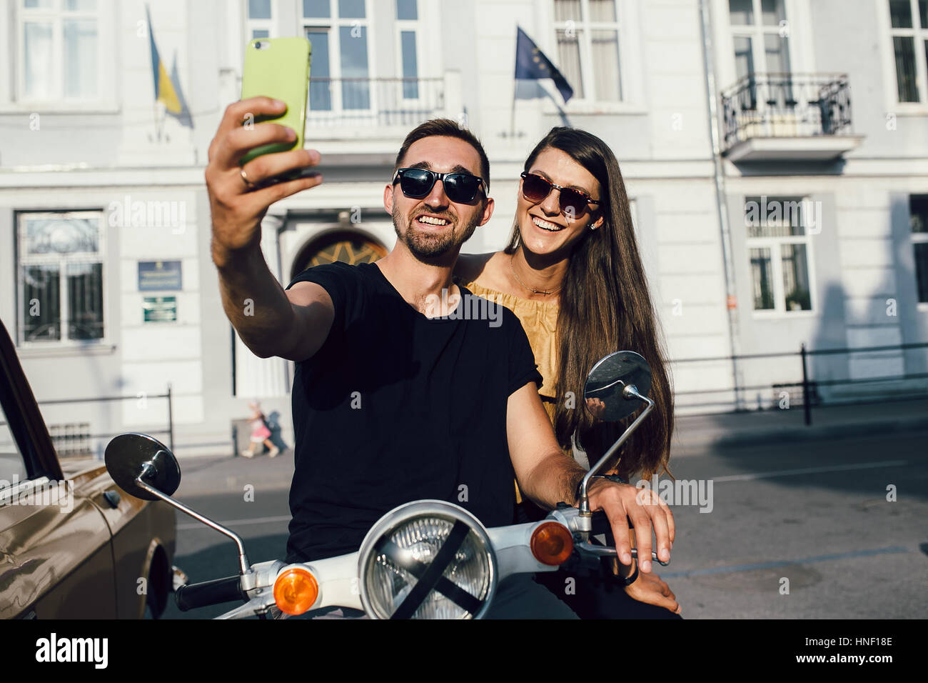 Cute couple make selfie on a scooter Stock Photo - Alamy