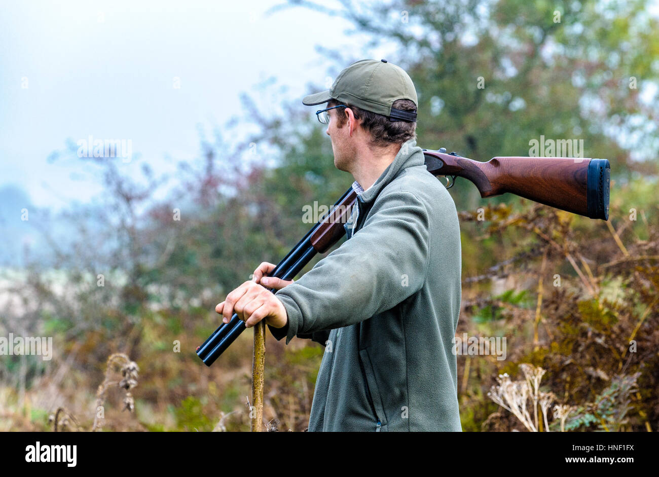 A man or hunter with a shotgun waiting on a days shooting Stock Photo ...