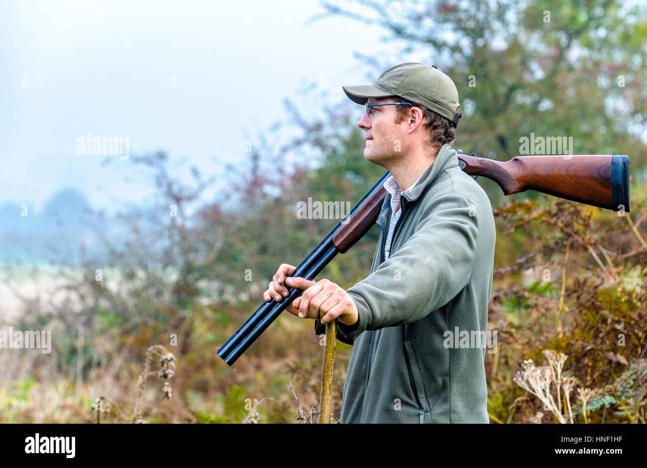 A man or hunter with a shotgun waiting on a days shooting Stock Photo ...