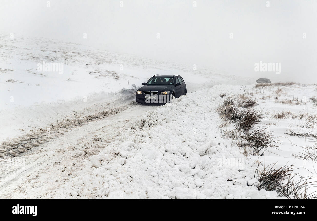 Cars navigate snowy conditions in Fleet Moss in the Yorkshire Dales as ...