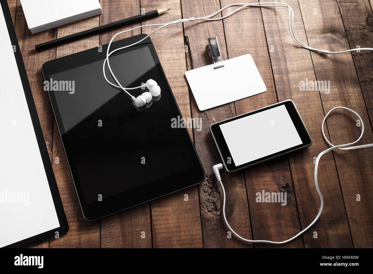 Tablet with blank screen, smartphone with blank screen, badge and ...