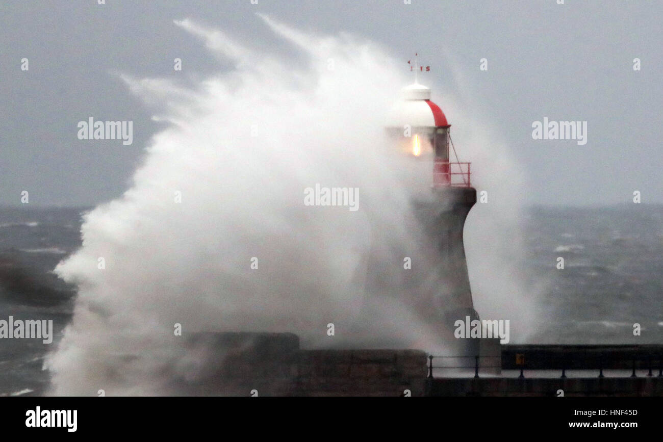 Pabest waves crash over lighthouse hi-res stock photography and images ...
