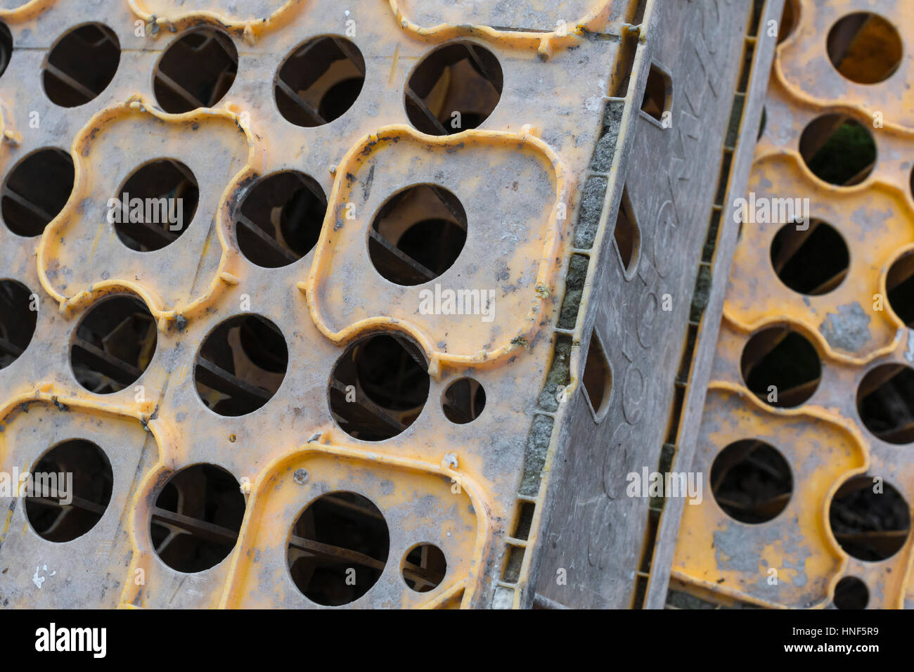 Couple of upturned discarded orange-yellow plastic crates. Trypophobia ...