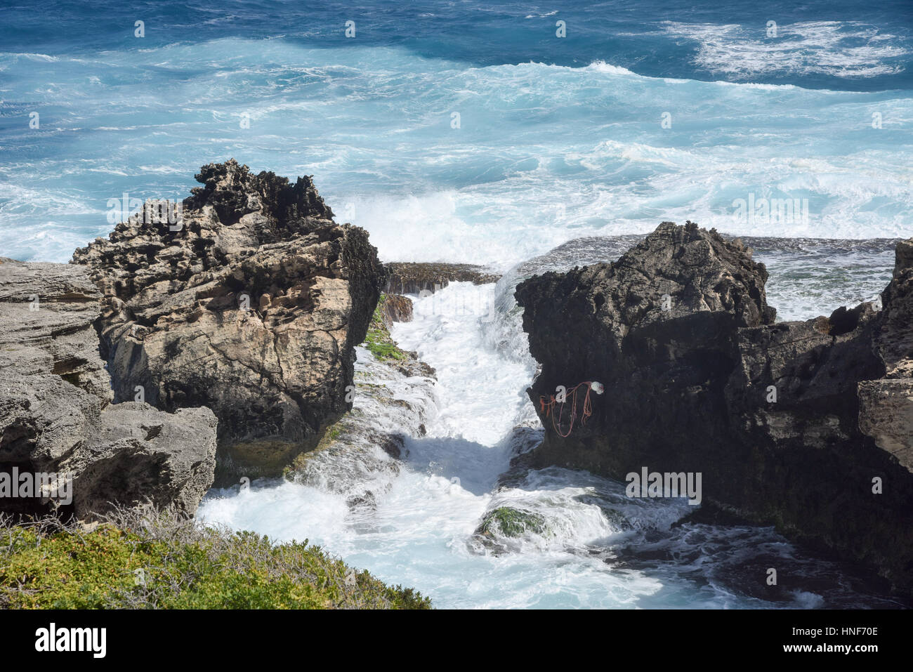 Limestone coastal rock formation with rushing Indian Ocean waters into ...
