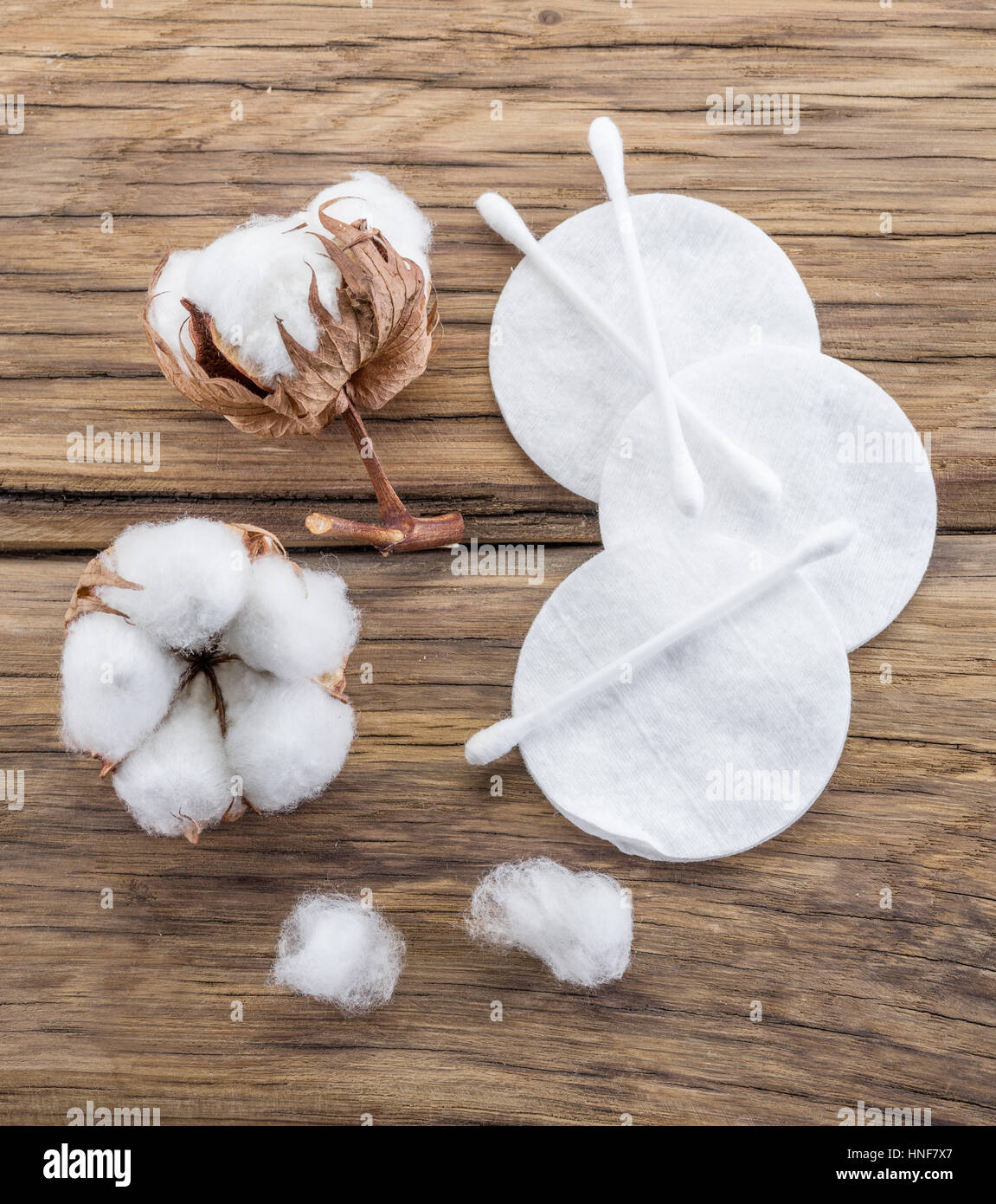 Fluffy cotton ball and cotton swabs and pads on wooden table Stock ...
