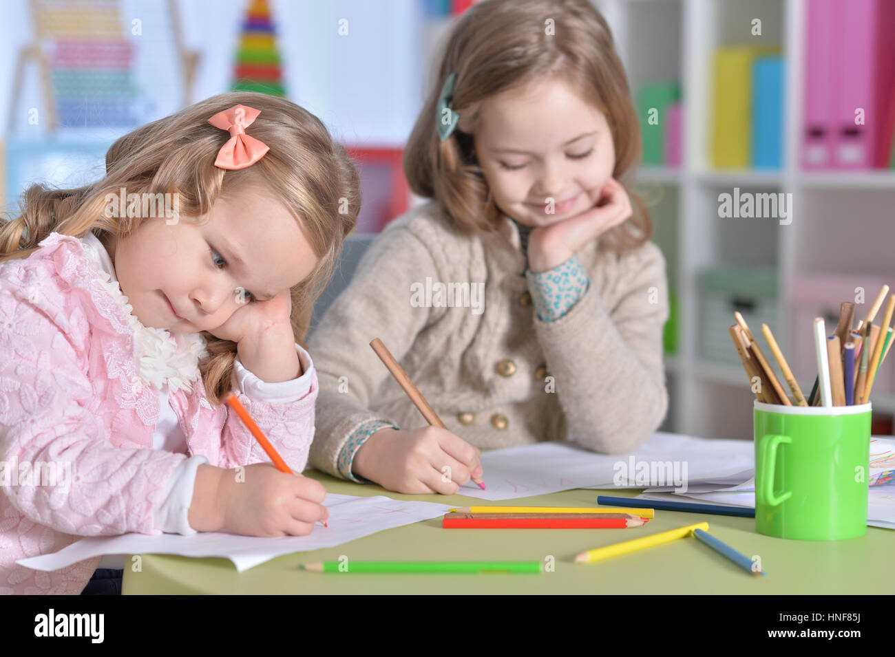 Two cute little girls drawing Stock Photo - Alamy