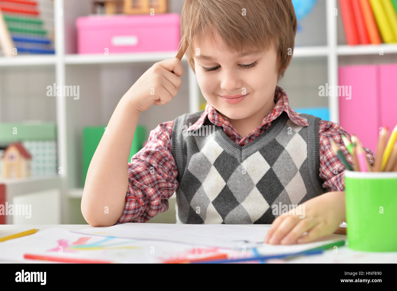 Little boy drawing with colorful pencils Stock Photo - Alamy