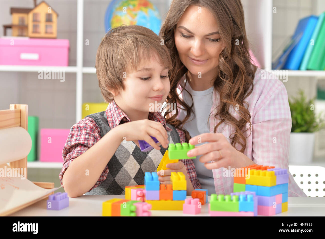 Woman and little boy playing lego Stock Photo - Alamy