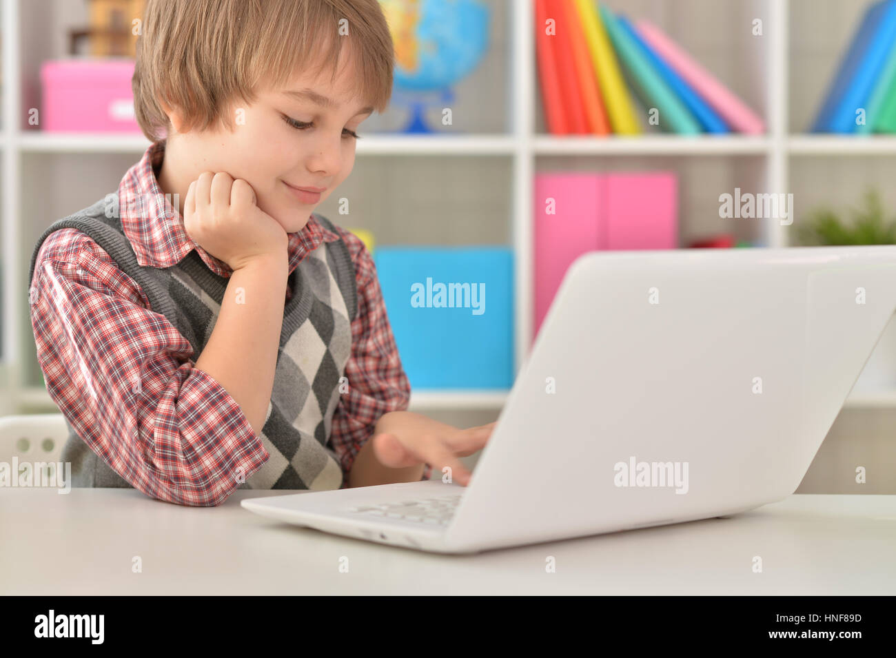 Boy using laptop Stock Photo - Alamy