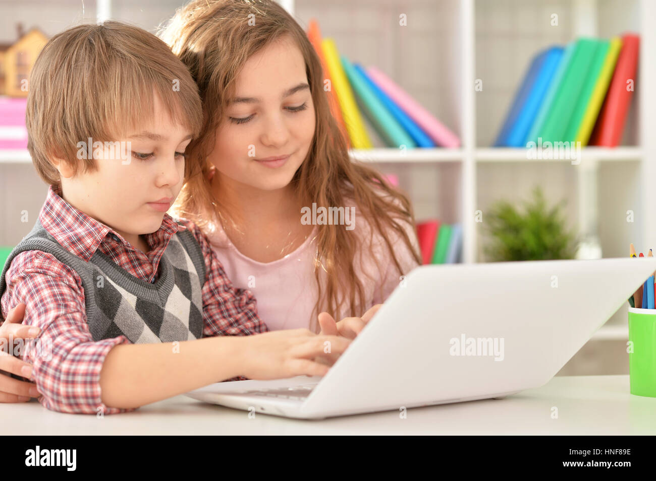 Boy and girl using laptop Stock Photo - Alamy