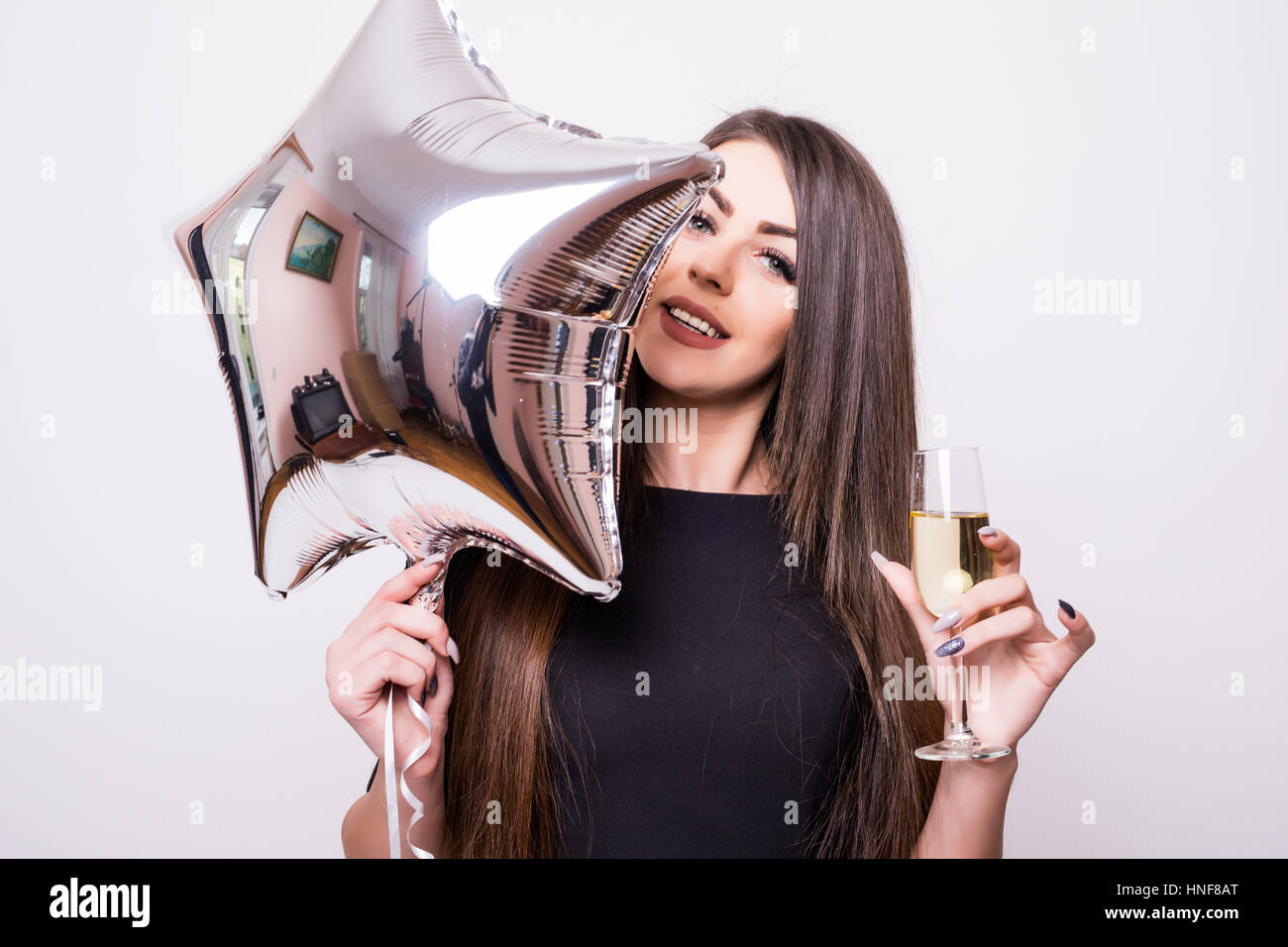 woman with star shaped balloon drinking champagne on white background ...
