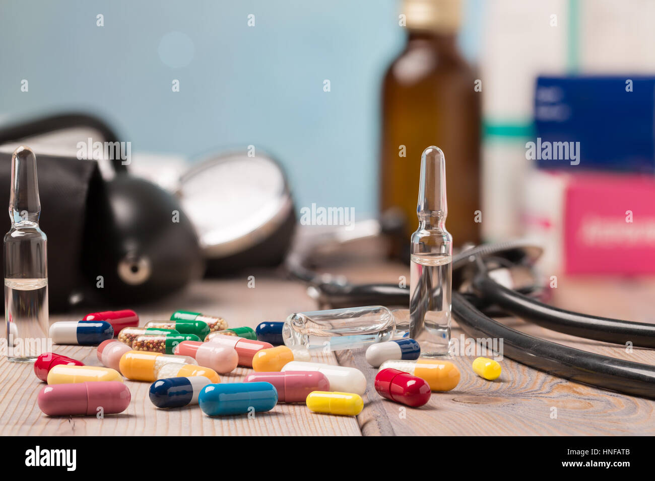 Various colorful capsules and medical equipment Stock Photo - Alamy