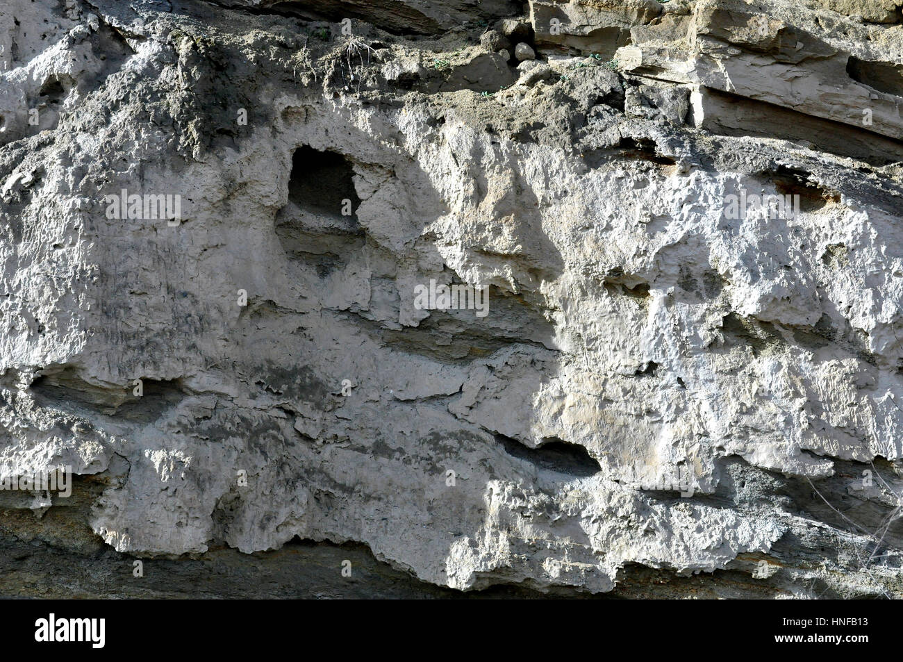 Strata of earth with holes Stock Photo - Alamy