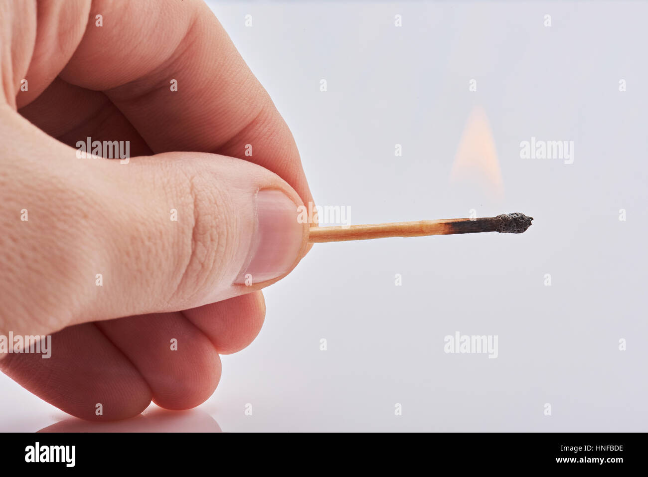 burning fire match in hand close up isolated on white background Stock ...