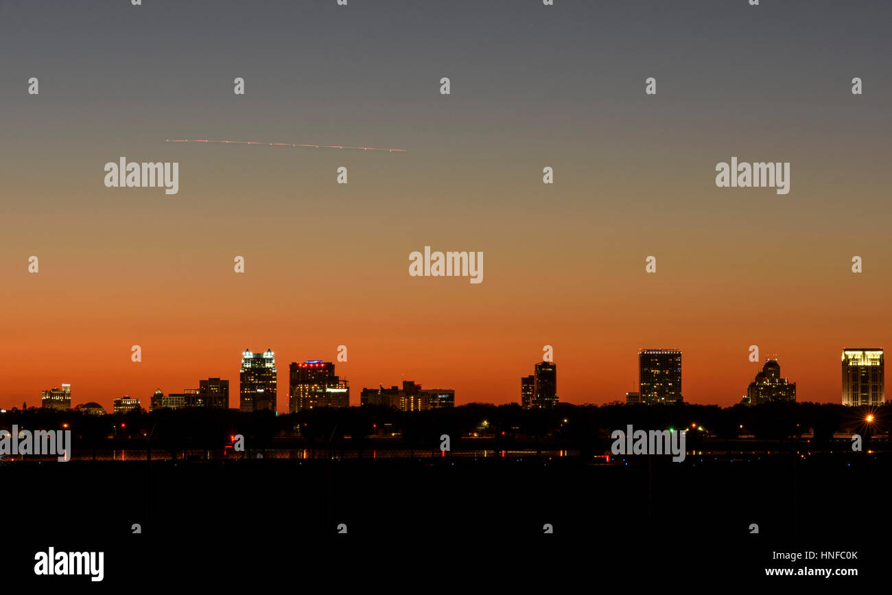 A small airplane's lights and the Orlando, Florida downtown skyline at ...