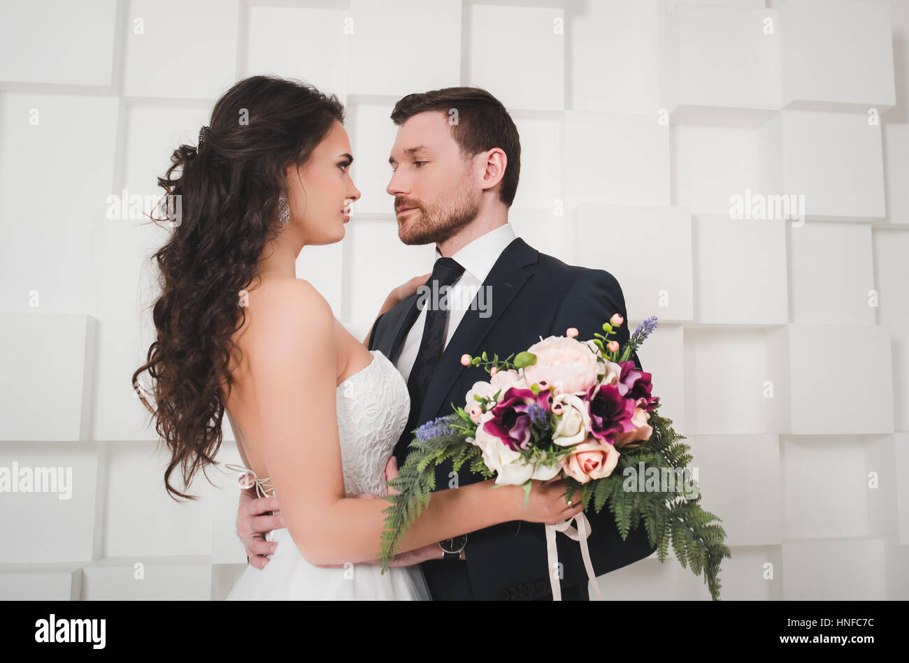 Just married young couple dancing, studio shot Stock Photo - Alamy