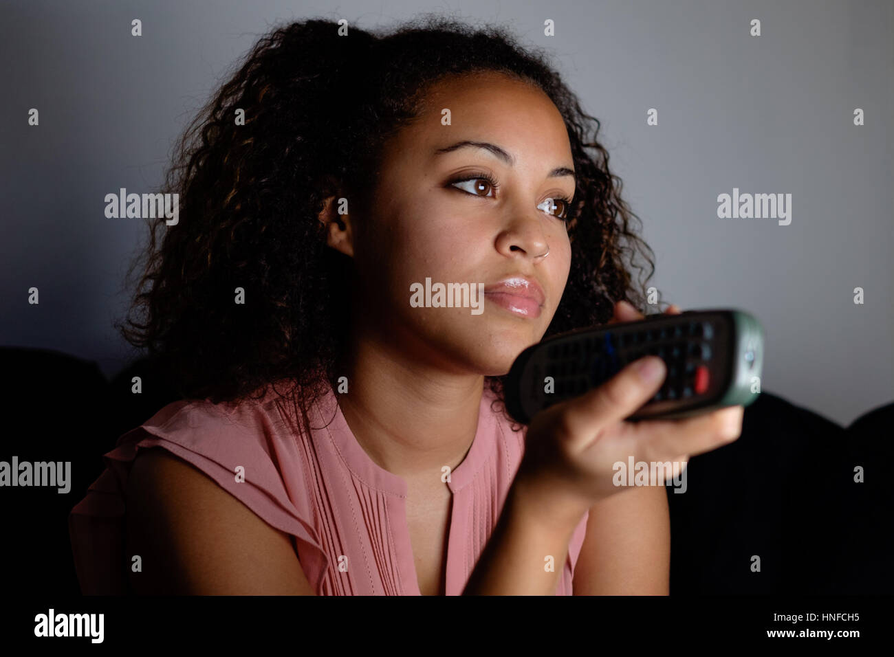 Woman holding tv remote hi-res stock photography and images - Alamy