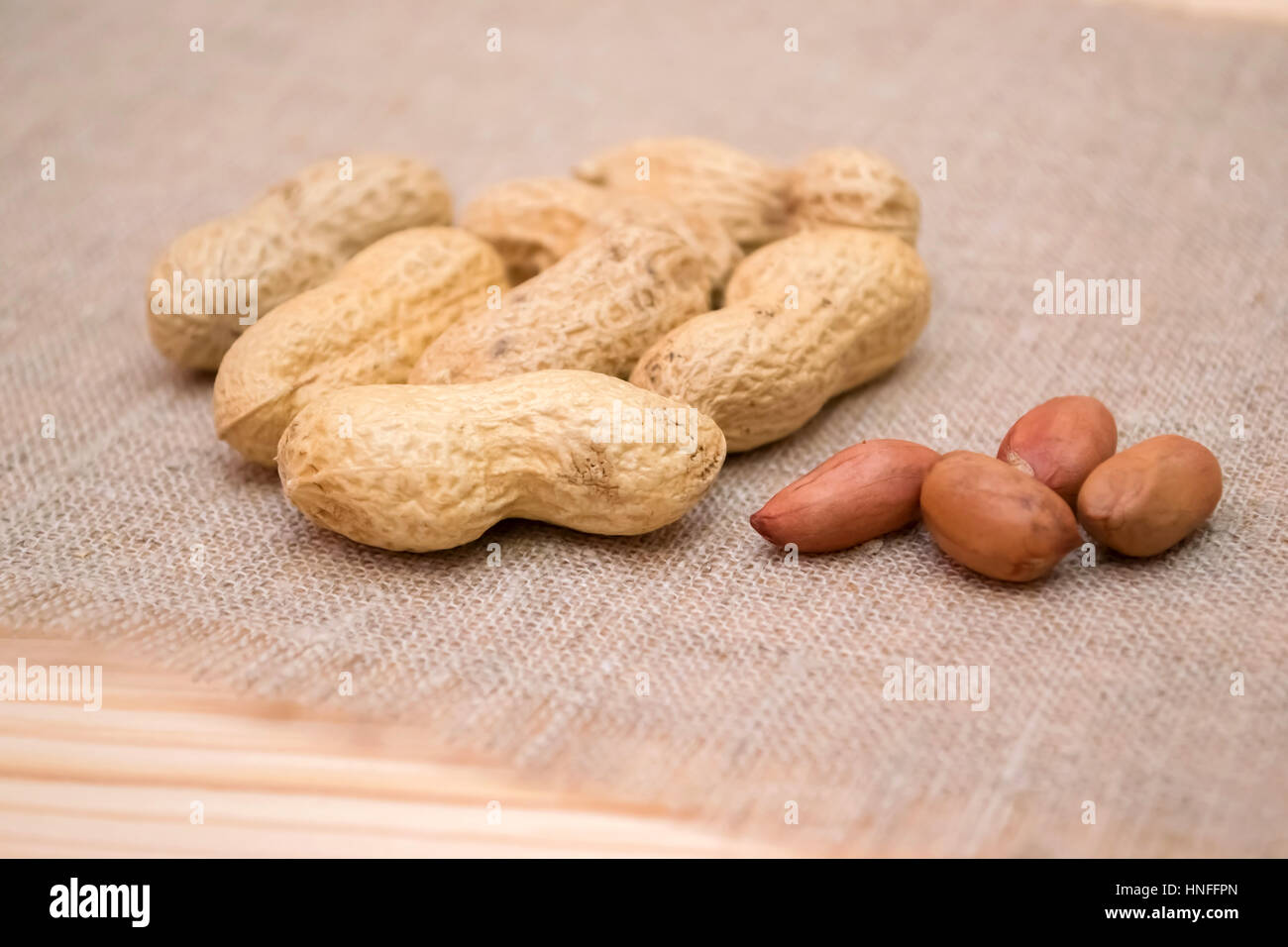 Peanut in a peel on a linen background Stock Photo - Alamy