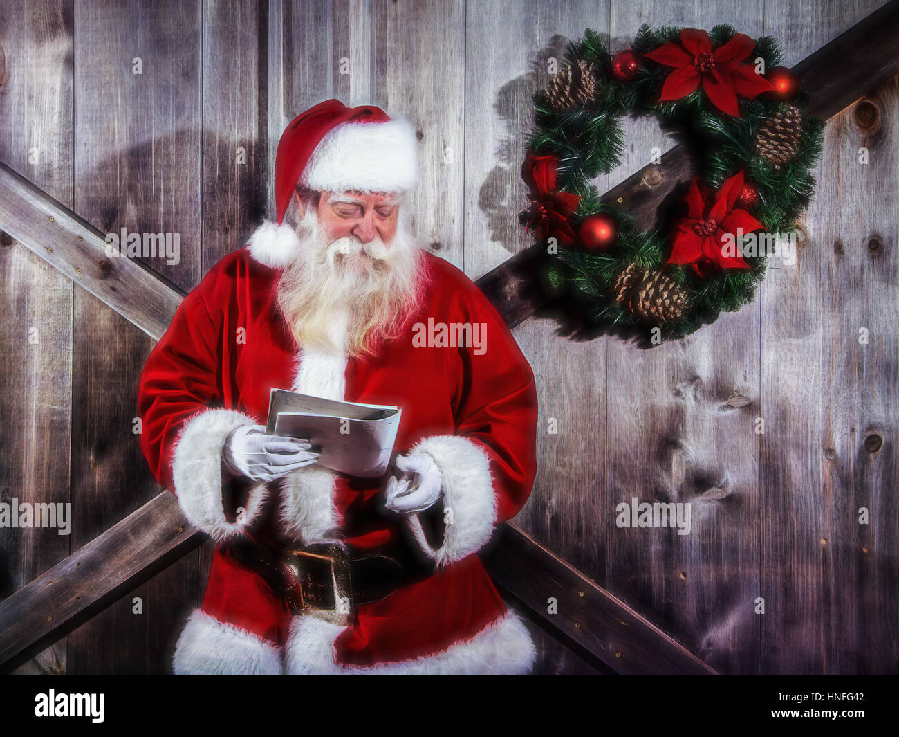 Santa reading delivery list Stock Photo - Alamy